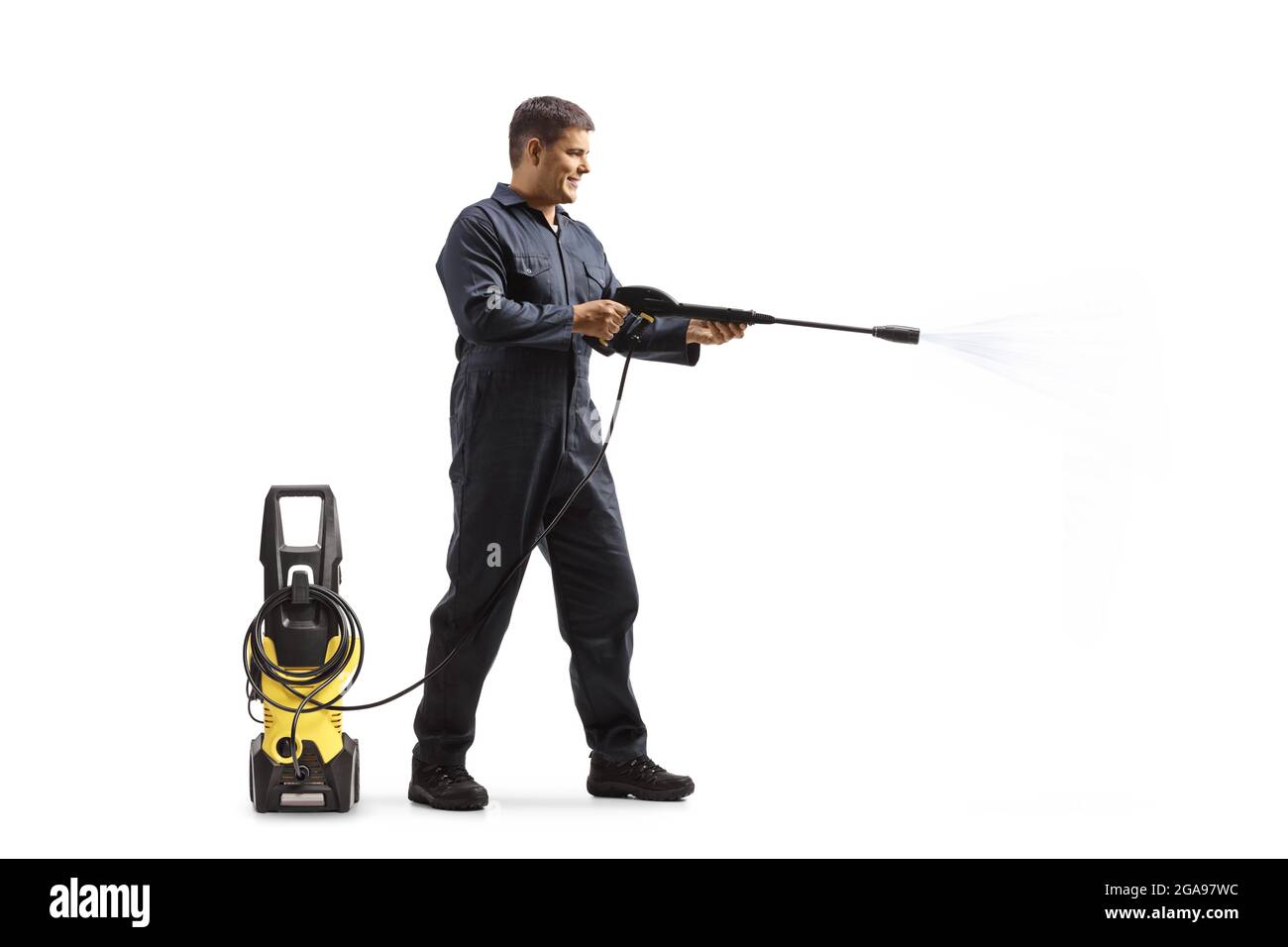 Full length profile shot of a man in a uniform spraying with a pressure ...