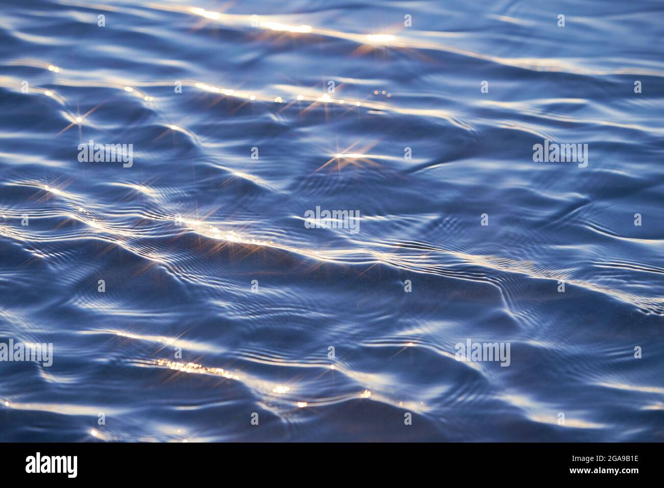 Detail of a sunlight reflecting in glittering sea. sparkler in water ...