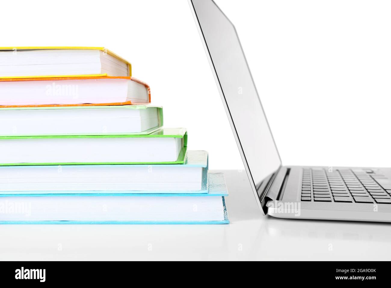 Stack of books with laptop close up Stock Photo - Alamy