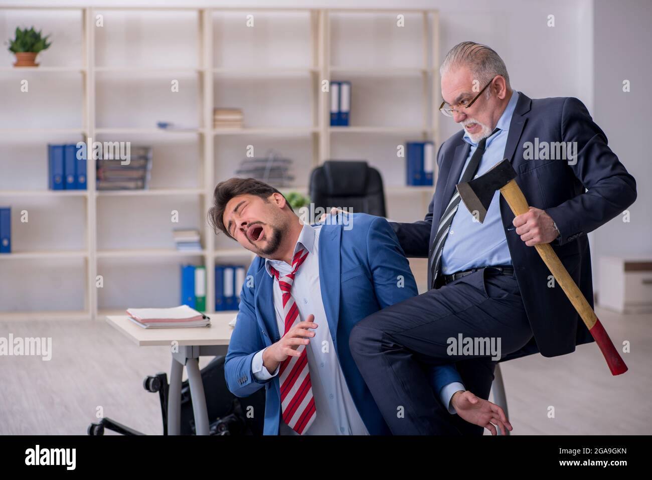 Old boss and young employee in bullying concept Stock Photo - Alamy