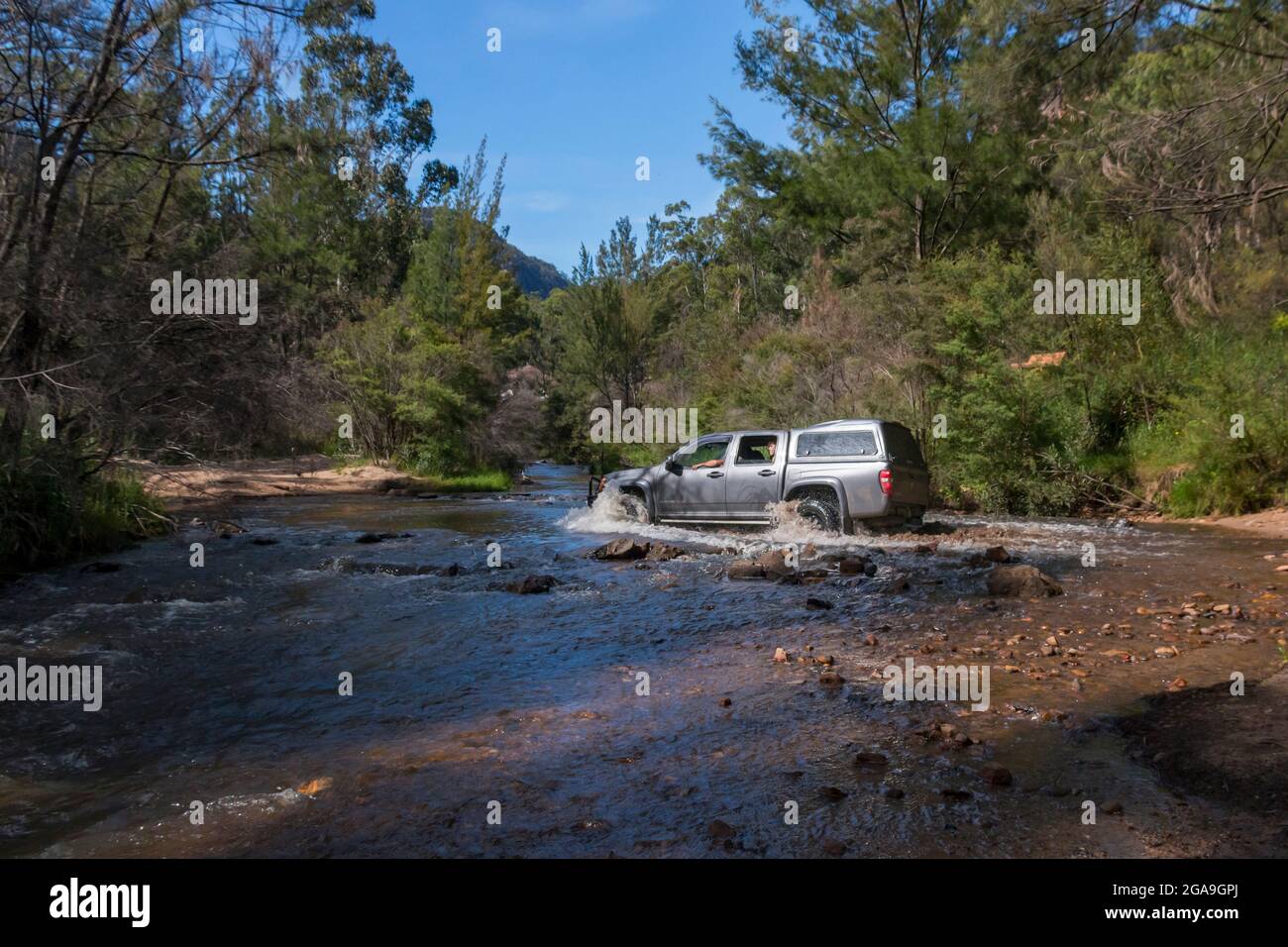 truck 4wd driving through a creek in the bush Stock Photo - Alamy