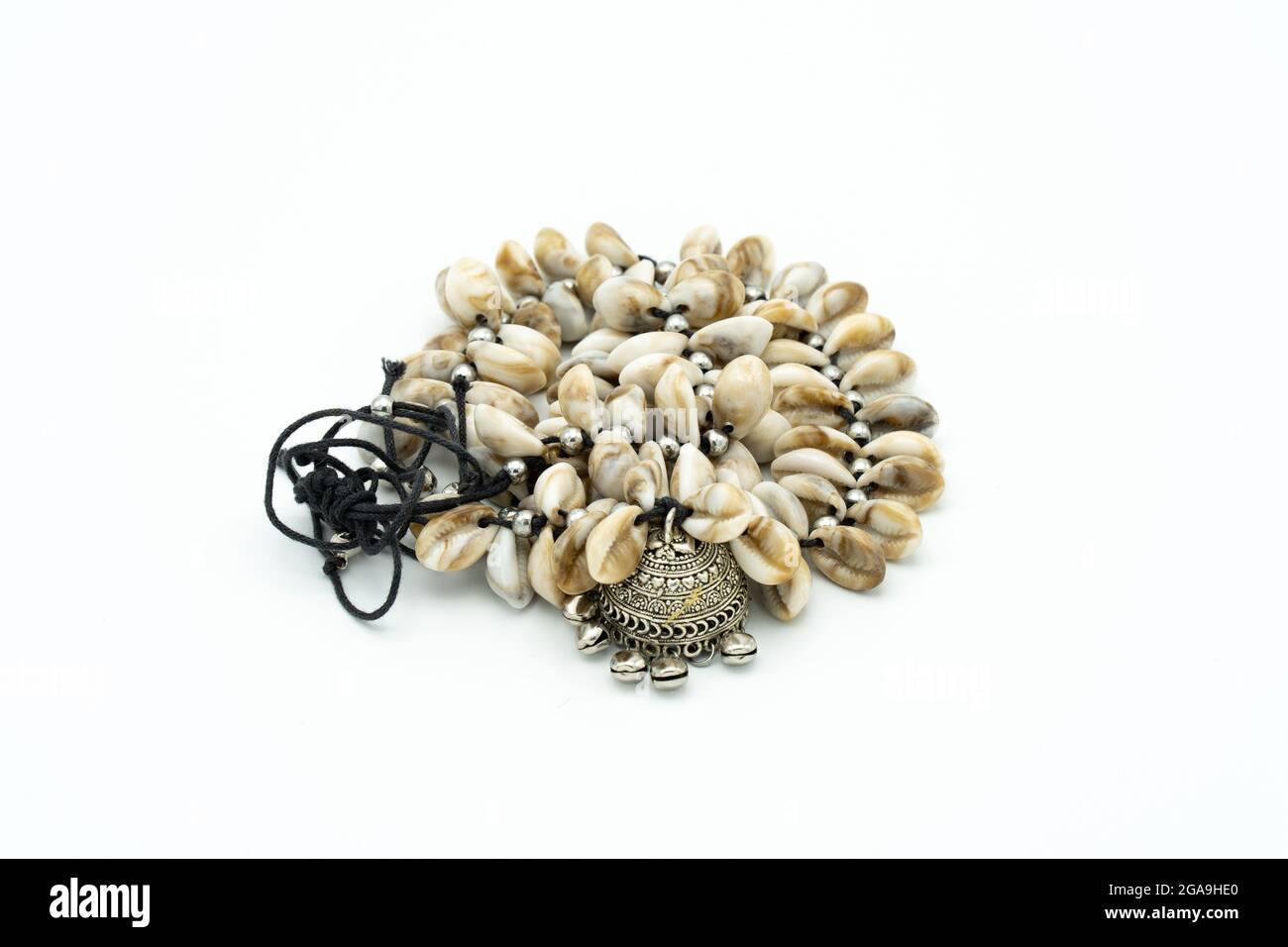 Traditional Indian necklace with seashells and a silver ornament on a ...