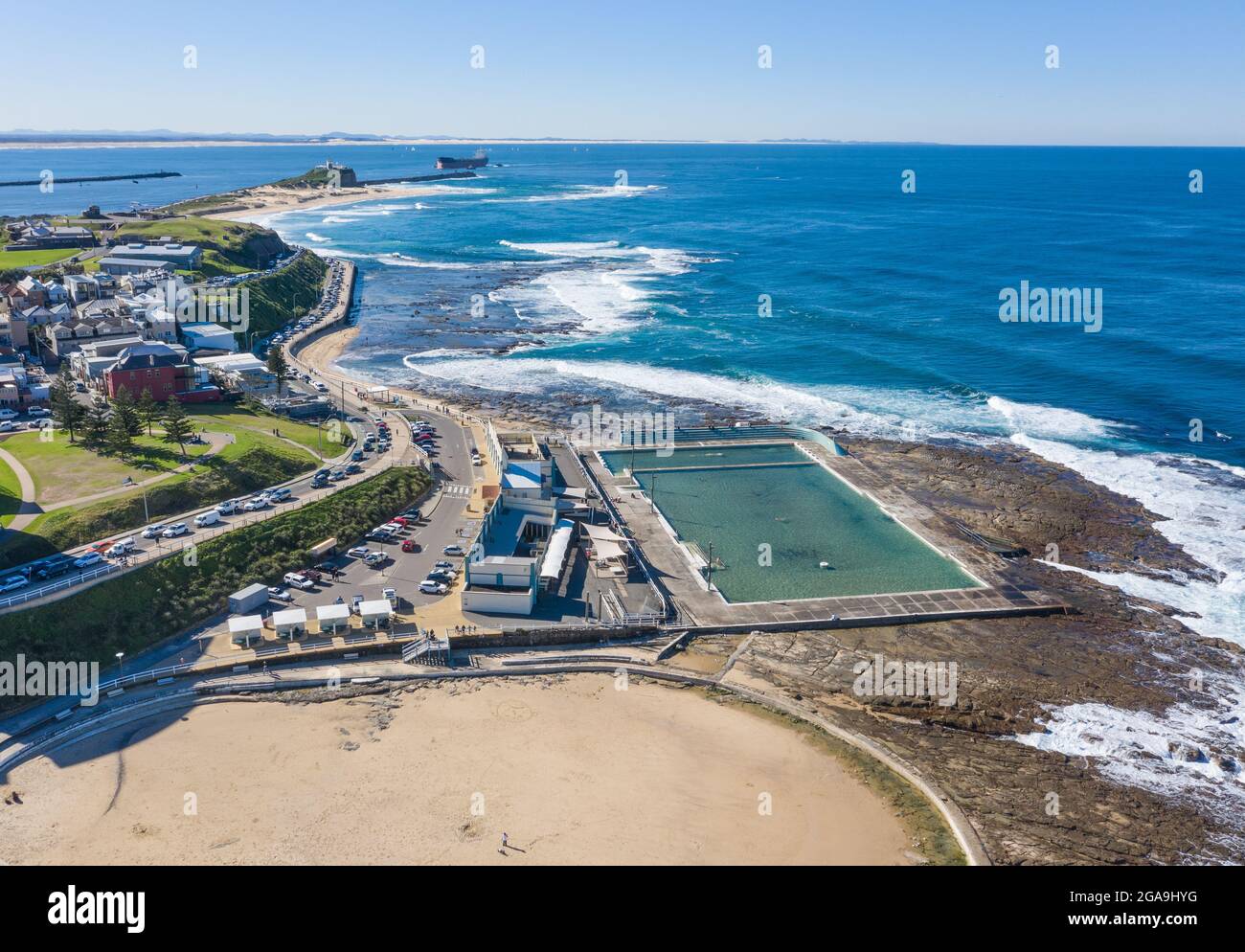 An aerial view of Newcastle Baths with ship entering port in the ...