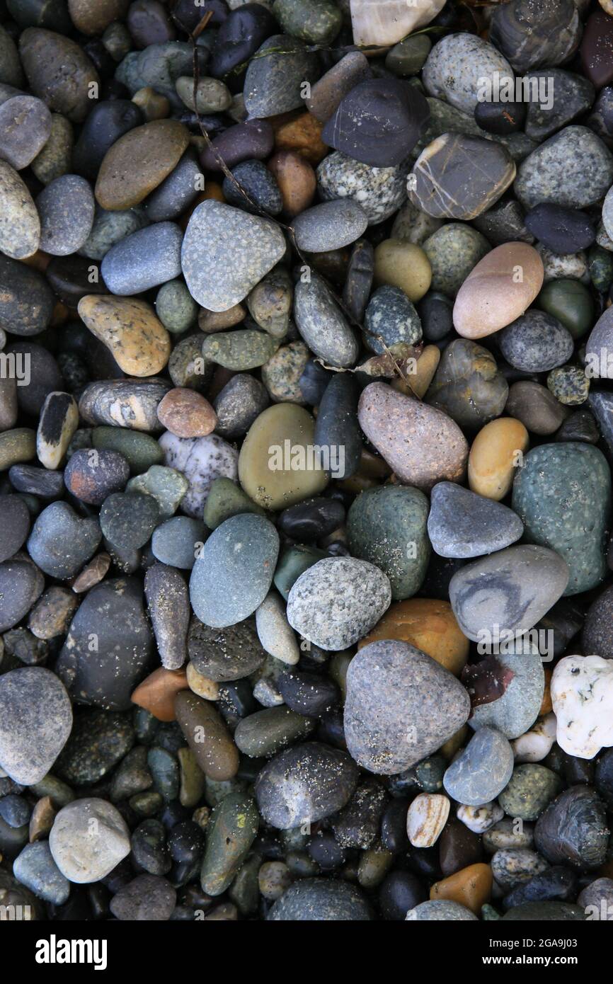 Vertical top view of small different-colored pebbles on a beach Stock ...