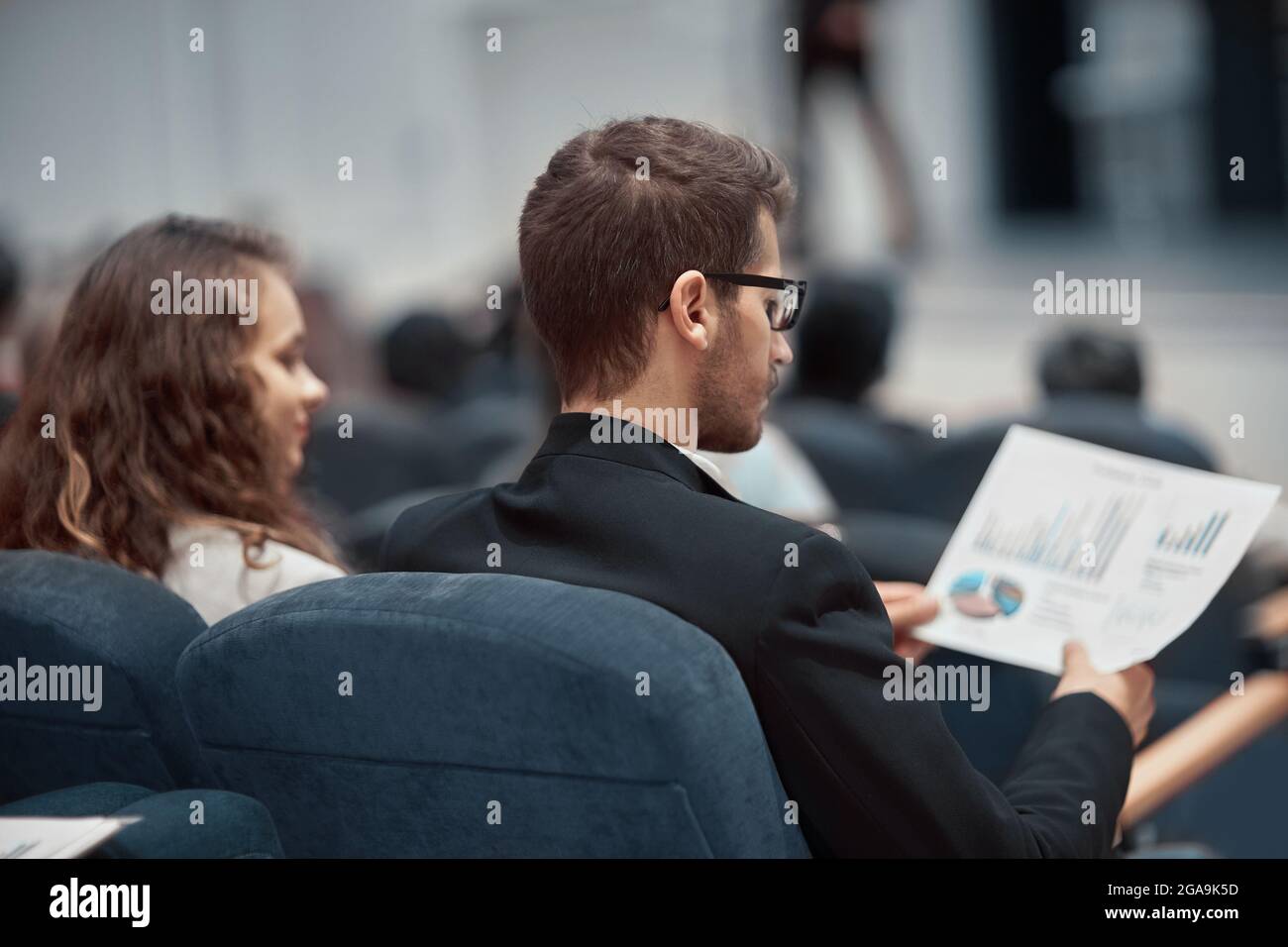 young business people sitting in the conference hall Stock Photo - Alamy