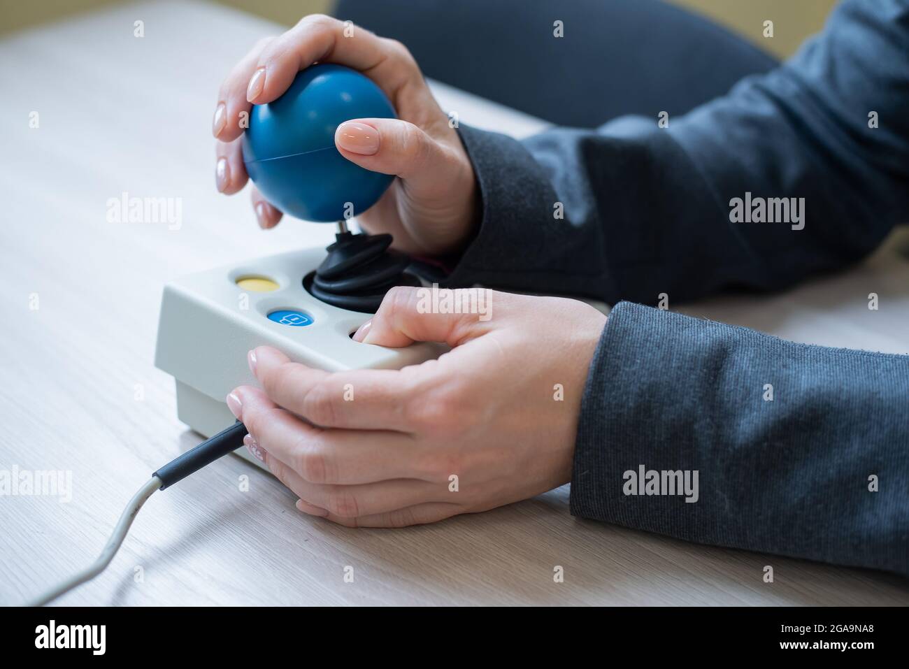 Woman with cerebral palsy works on a specialized computer mouse Stock ...
