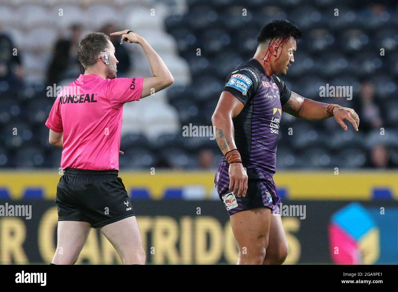 referee Liam Moore signals a head wound to Zane Tetevano (13) of Leeds ...