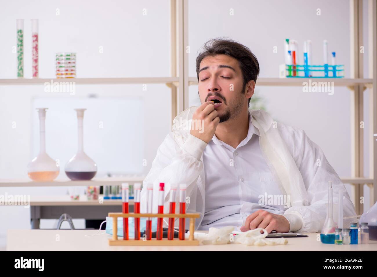Young chemist extremely tired at the lab Stock Photo - Alamy