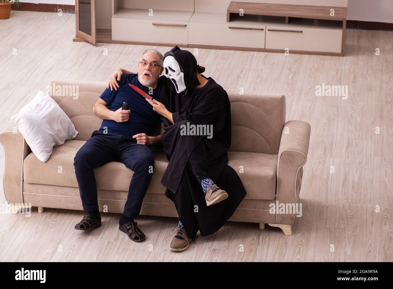 Devil coming to old dying man Stock Photo - Alamy