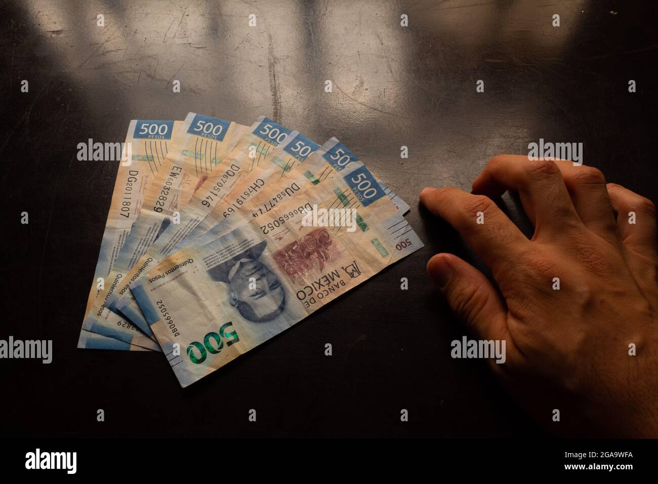 hand holding mexican money called pesos Stock Photo - Alamy