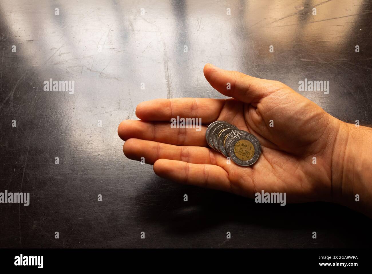 hand holding mexican money called pesos Stock Photo - Alamy