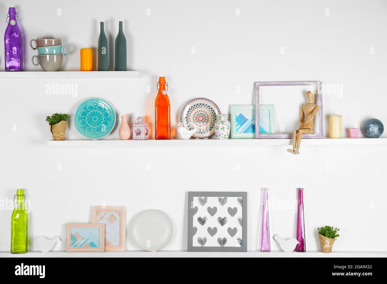 Wooden shelves with decorative things in room Stock Photo - Alamy