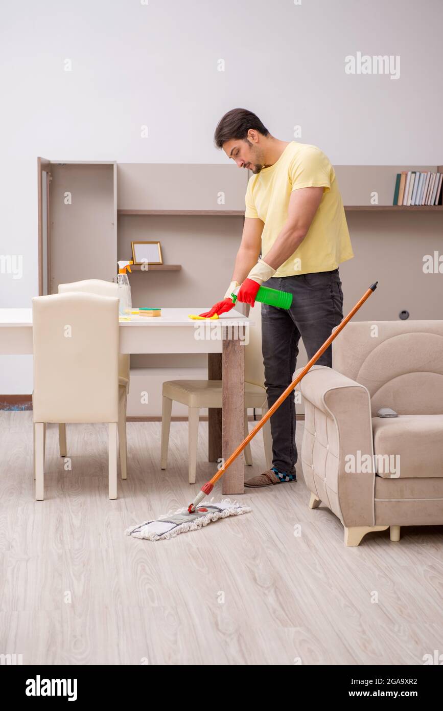 Young male cleaner cleaning the house Stock Photo - Alamy