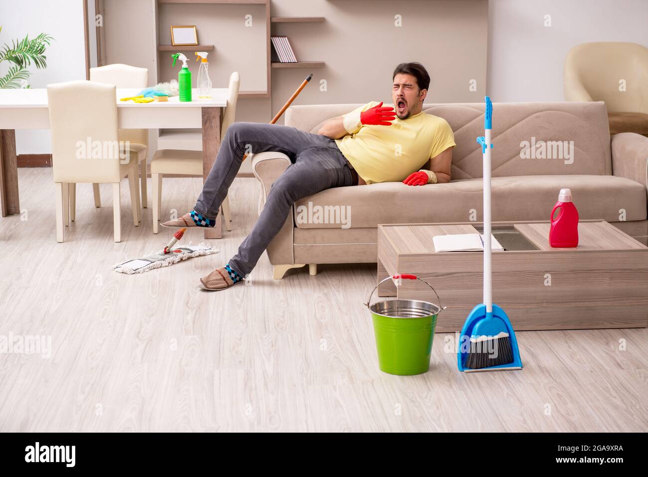 Young male cleaner cleaning the house Stock Photo - Alamy