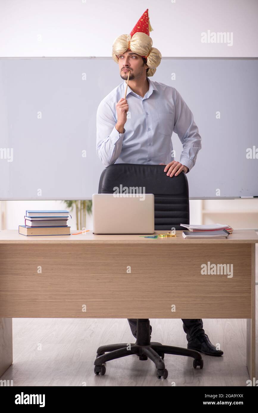 Funny young teacher magician in the classroom Stock Photo - Alamy