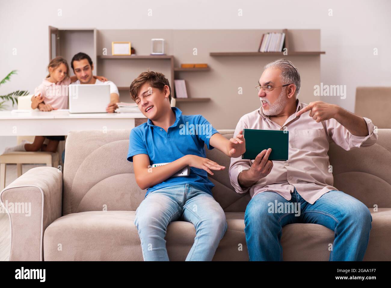 Three generations at home in early development concept Stock Photo - Alamy