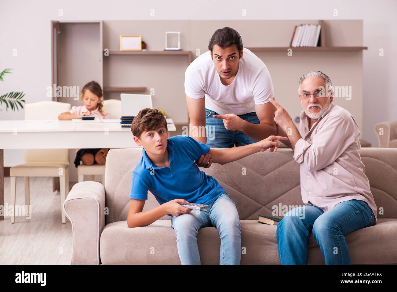 Three generations family watching tv hi-res stock photography and ...