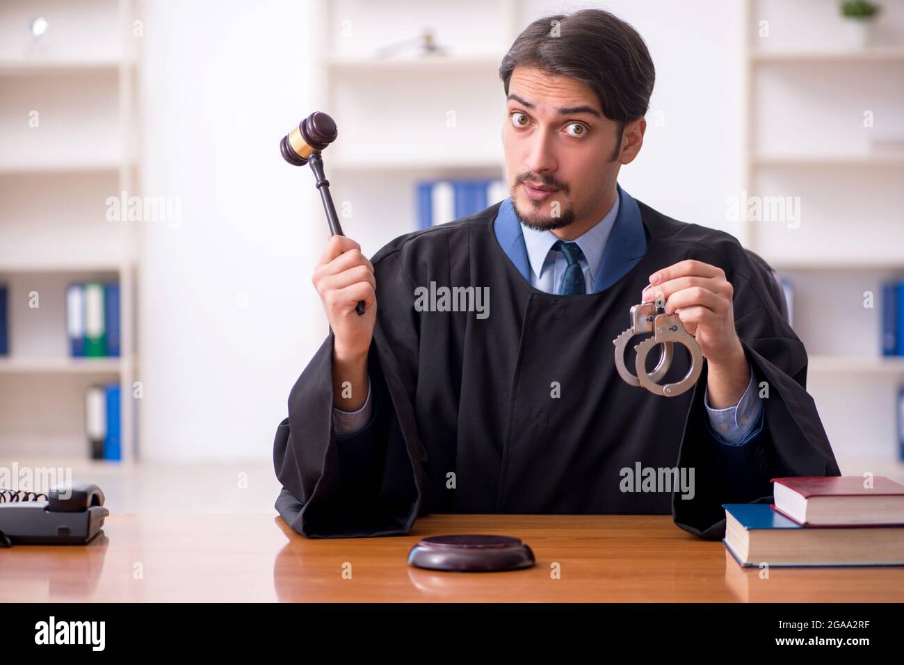 Young judge working in the courtroom Stock Photo - Alamy