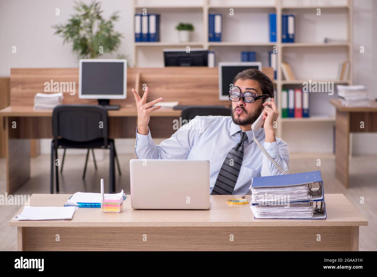 Young funny employee working at workplace Stock Photo - Alamy