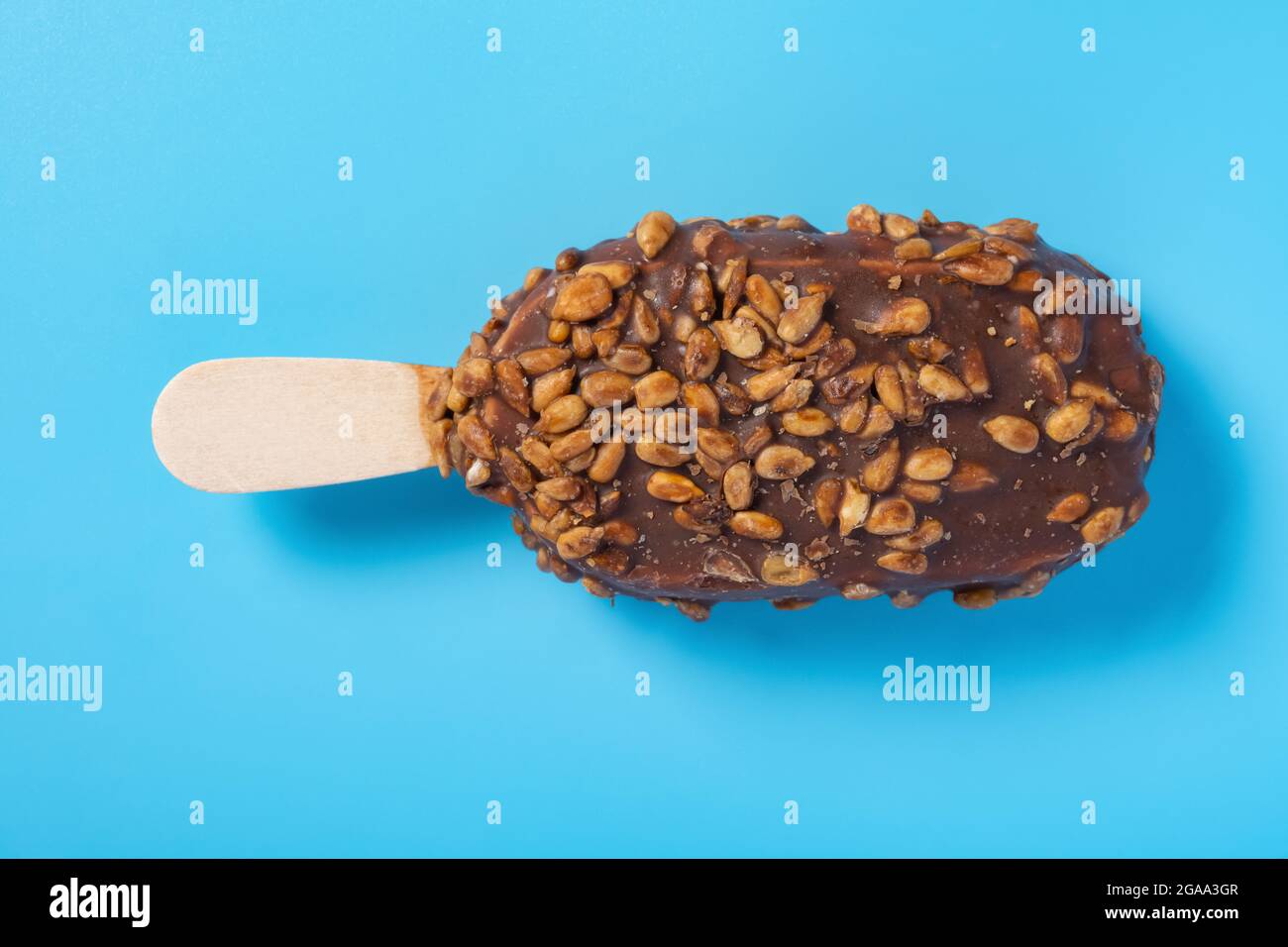 top view chocolate outer popsicle with melon seeds on blue background ...