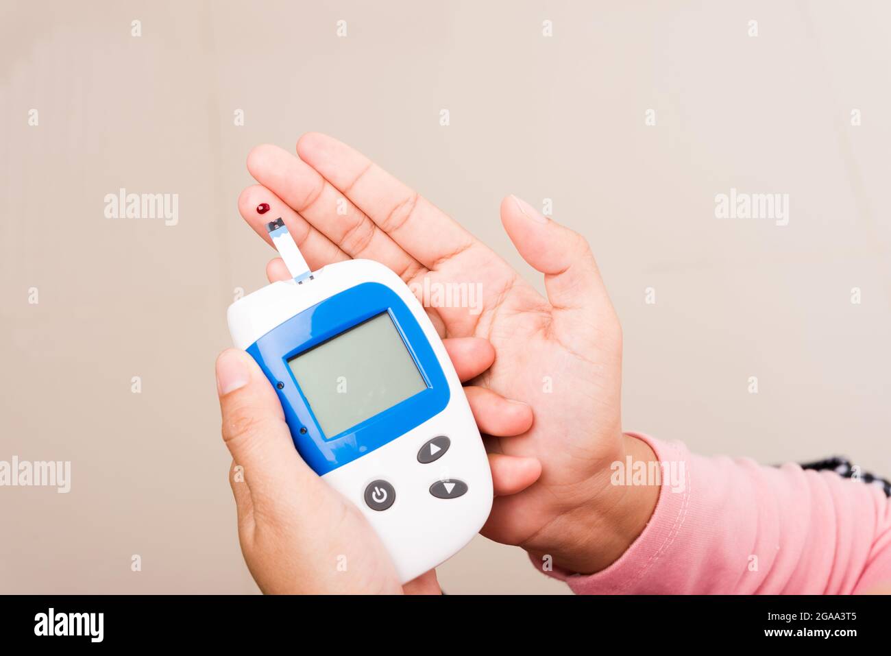 Closeup Hands woman measuring glucose test level check with blood on ...