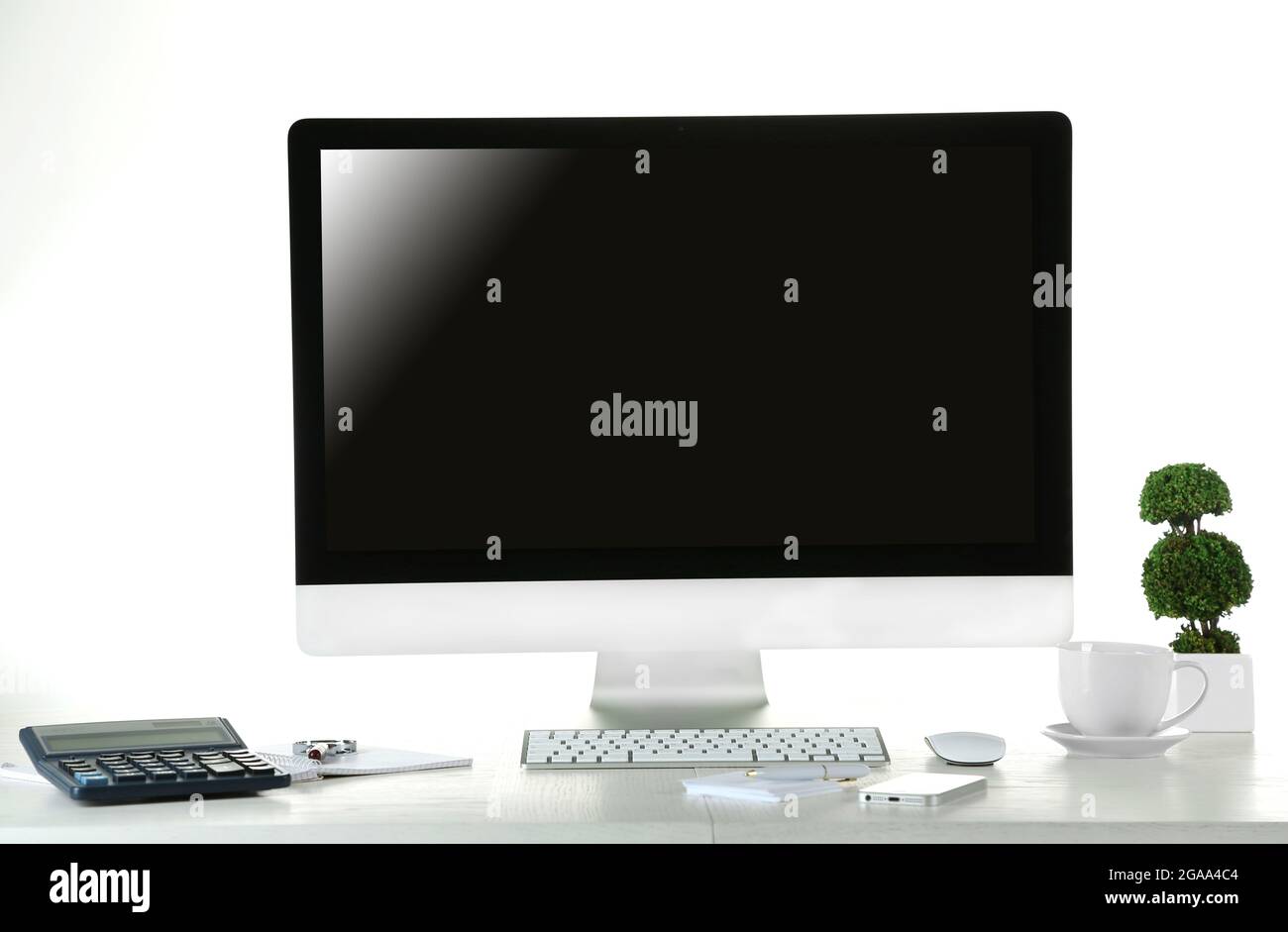 Computer on wooden table with blank white background Stock Photo - Alamy