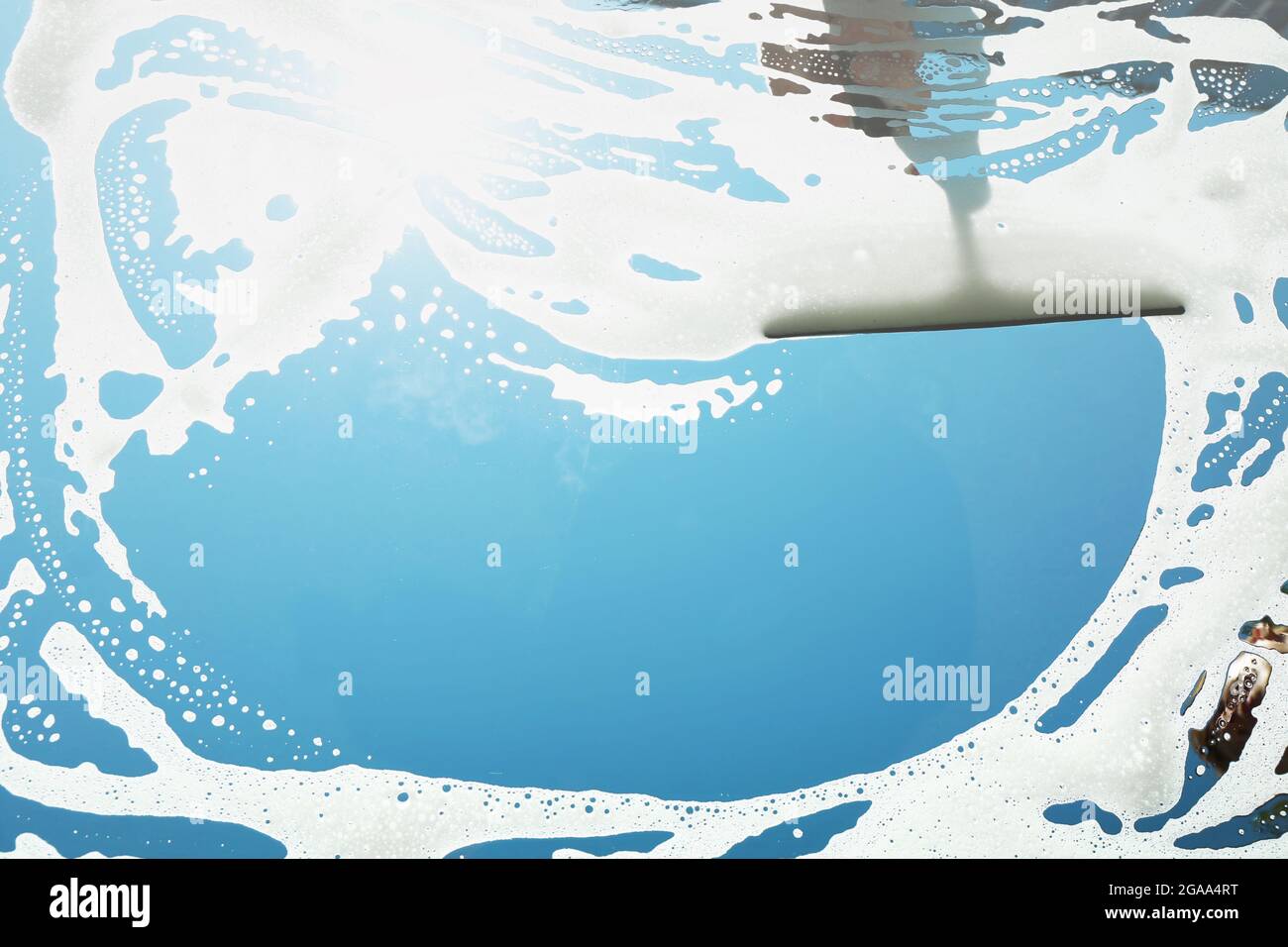 Washing window with soap and foam, closeup Stock Photo - Alamy