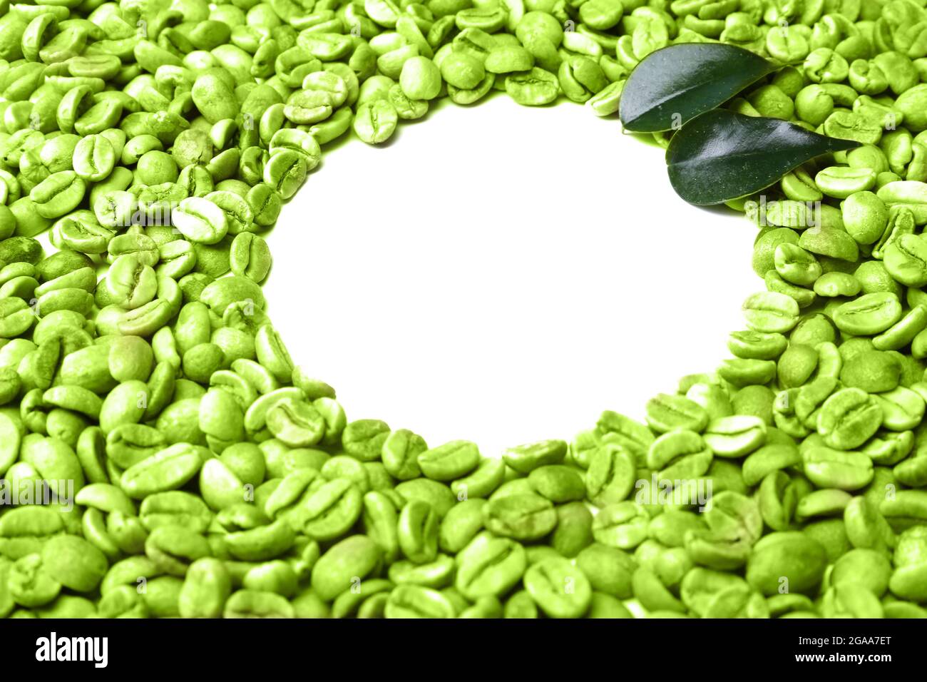 Green coffee beans with leaves close up Stock Photo - Alamy