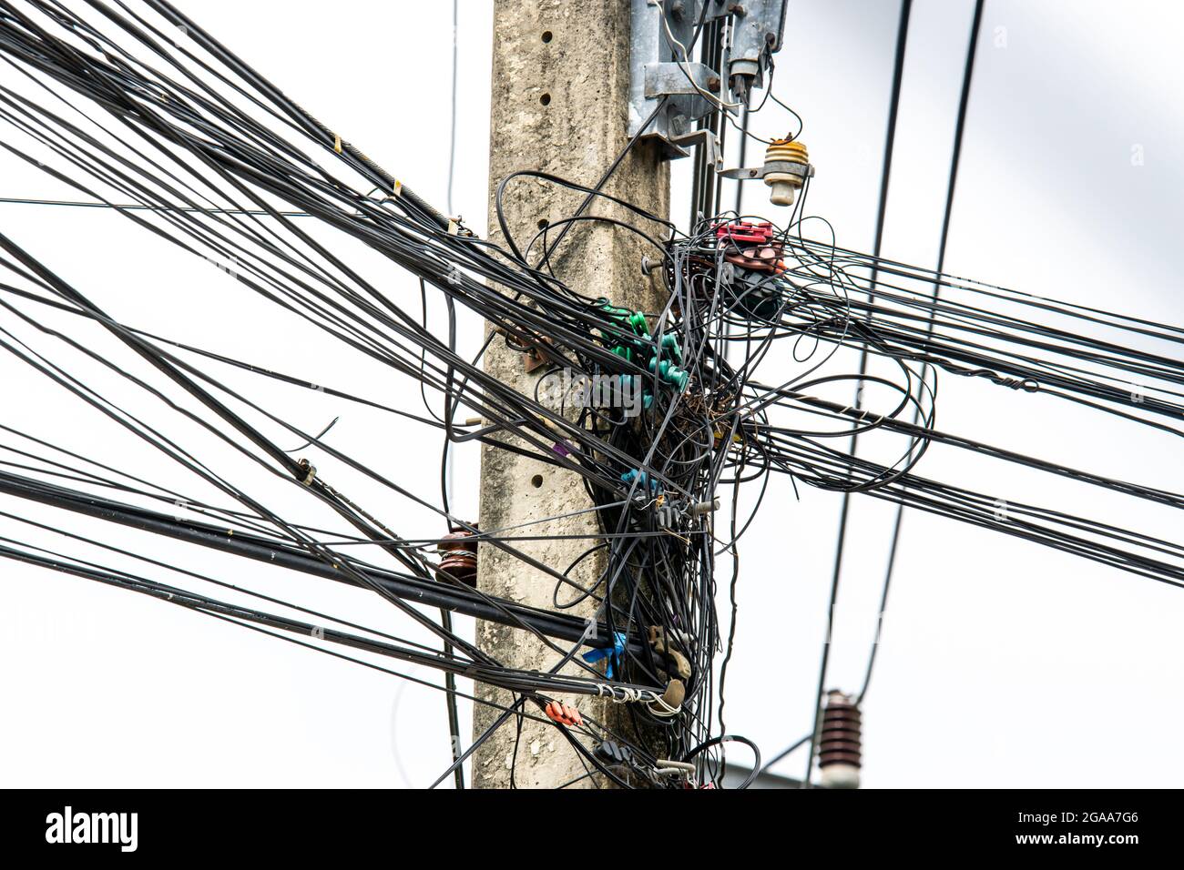 Disorder messy line of black electrical wires on old power pole ...