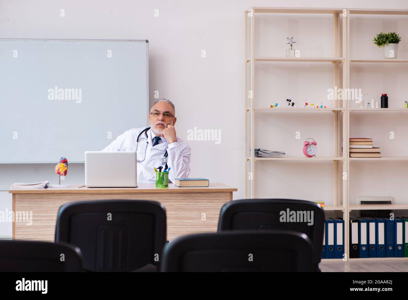 Old doctor lecturer in the classroom during pandemic Stock Photo - Alamy