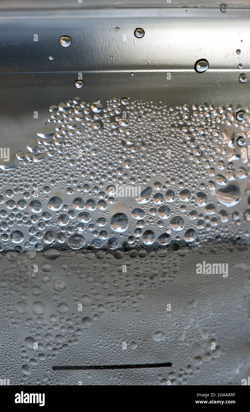 Condensation drops cling to the side of a clear plastic disposable ...