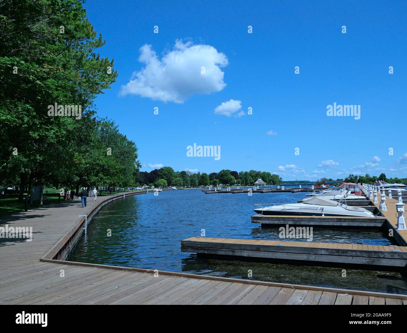 Public park with boardwalk and marina along a lake on a sunny summer ...