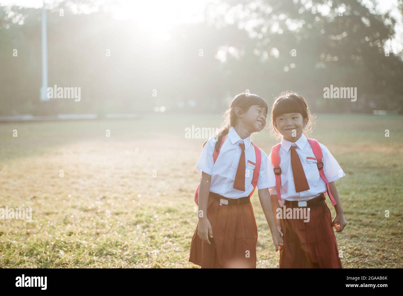 happy female asian primary school student walk together Stock Photo - Alamy