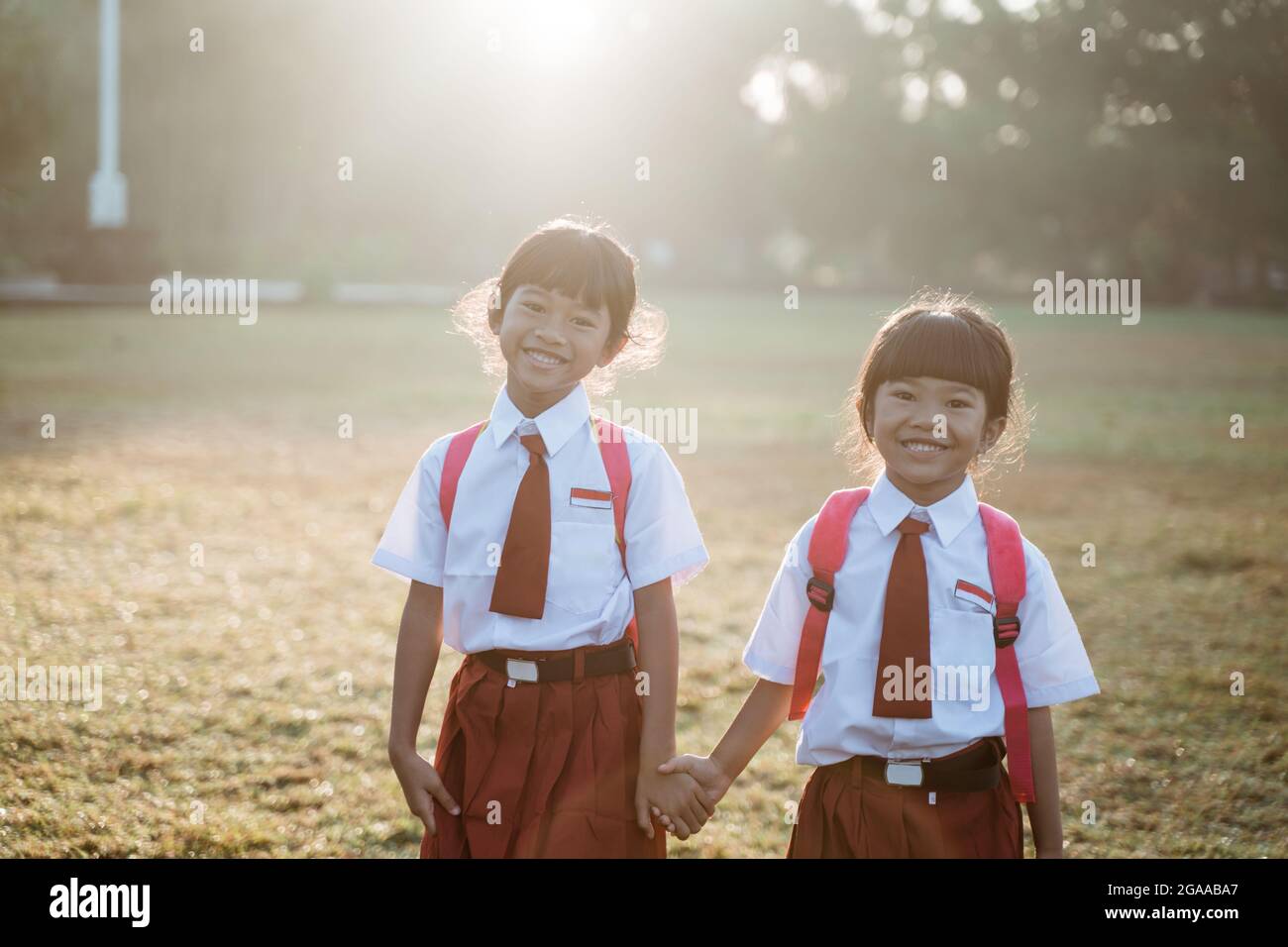 happy female asian primary school student walk together Stock Photo - Alamy
