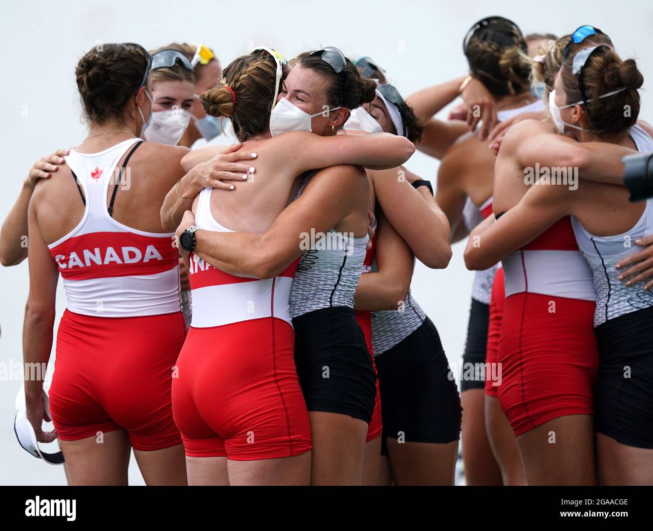 The Canada team celebrate with the New Zealand team after winning the ...