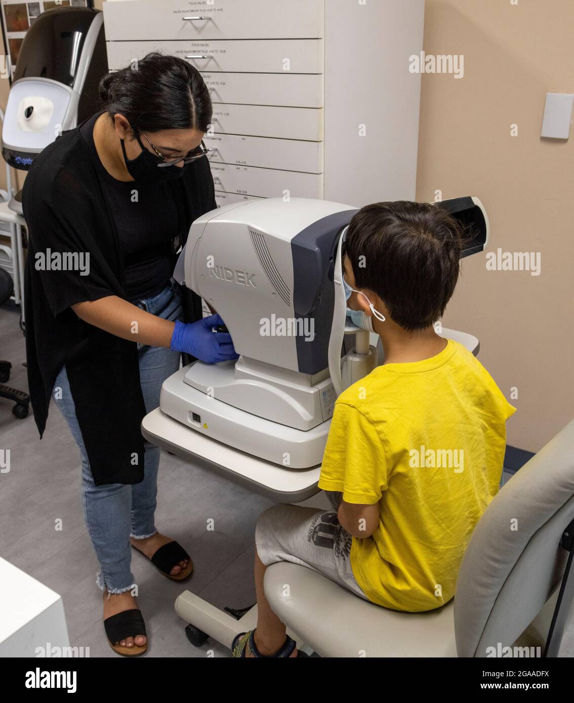 Boy getting eye exam at optometrist's office, USA Stock Photo - Alamy