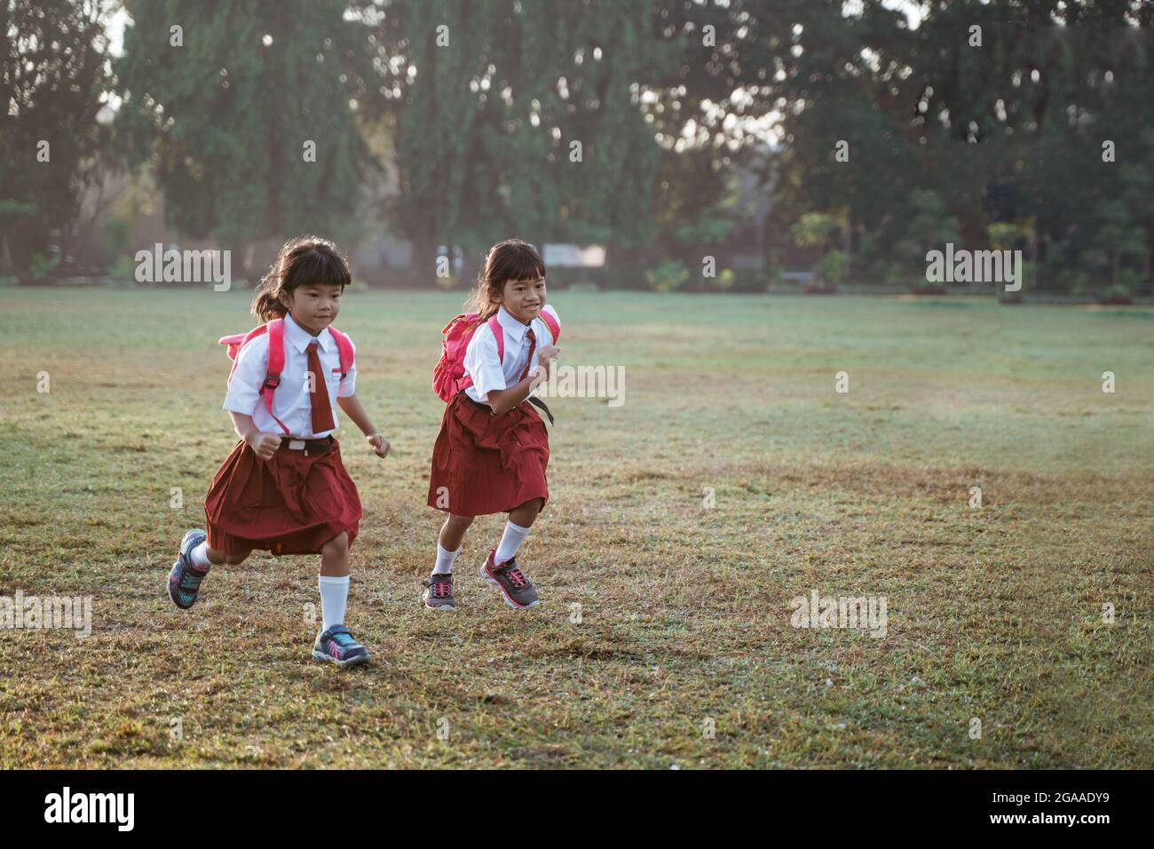 little girl student running together while going to their school Stock ...