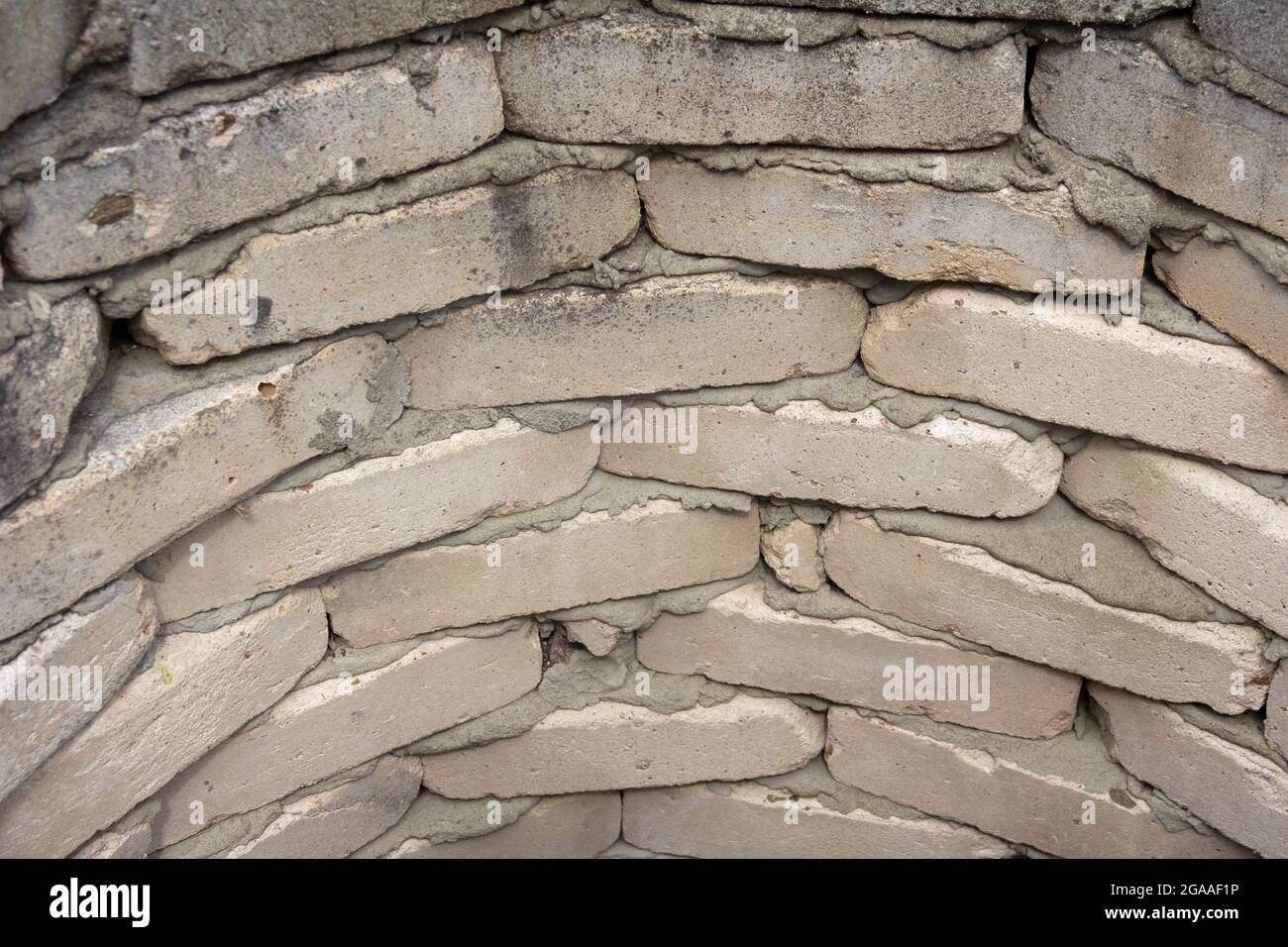 Brickwork in a semicircle of white, gray bricks. The wall of an old ...