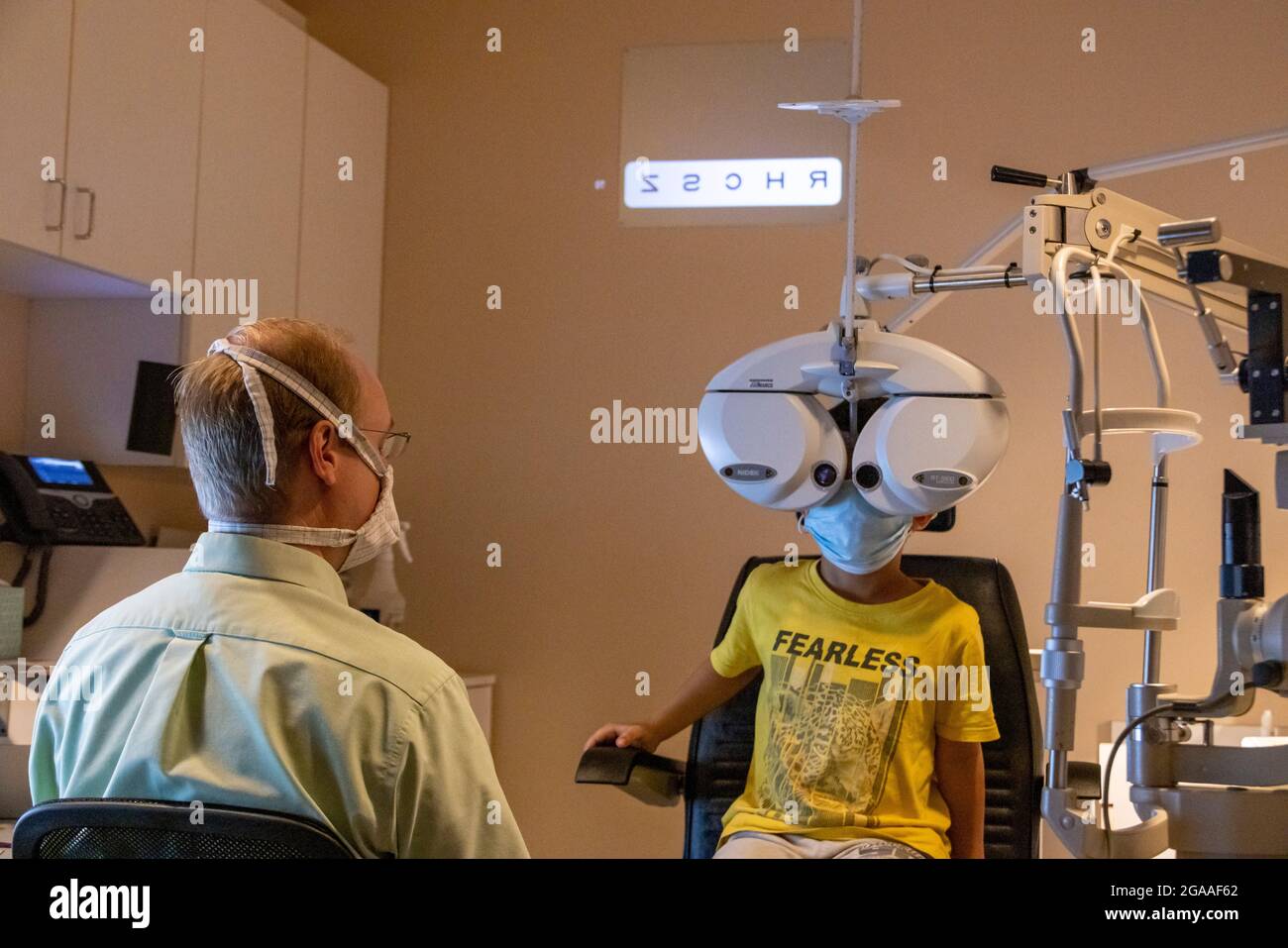 Boy getting eye exam at optometrist's office, USA Stock Photo - Alamy