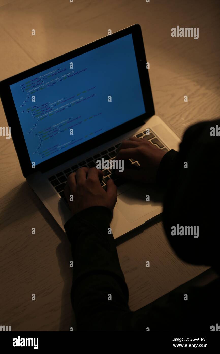 Hacker with laptop Stock Photo - Alamy