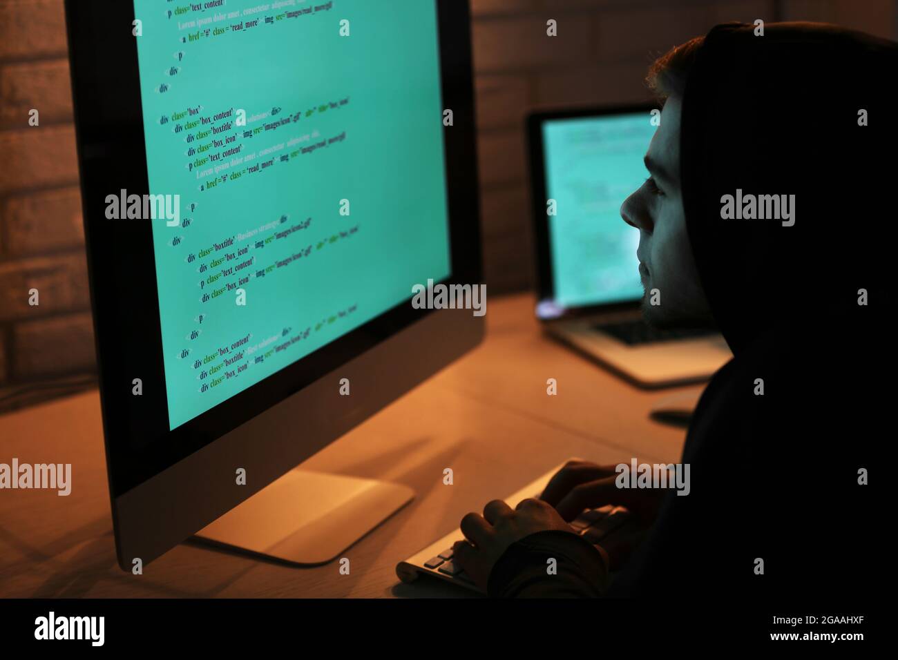 Hacker with computer and laptop Stock Photo - Alamy