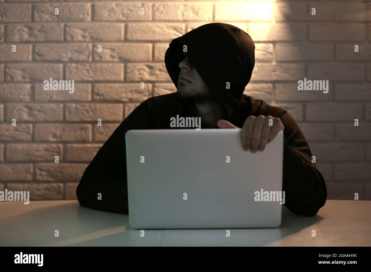 Hacker with laptop Stock Photo - Alamy