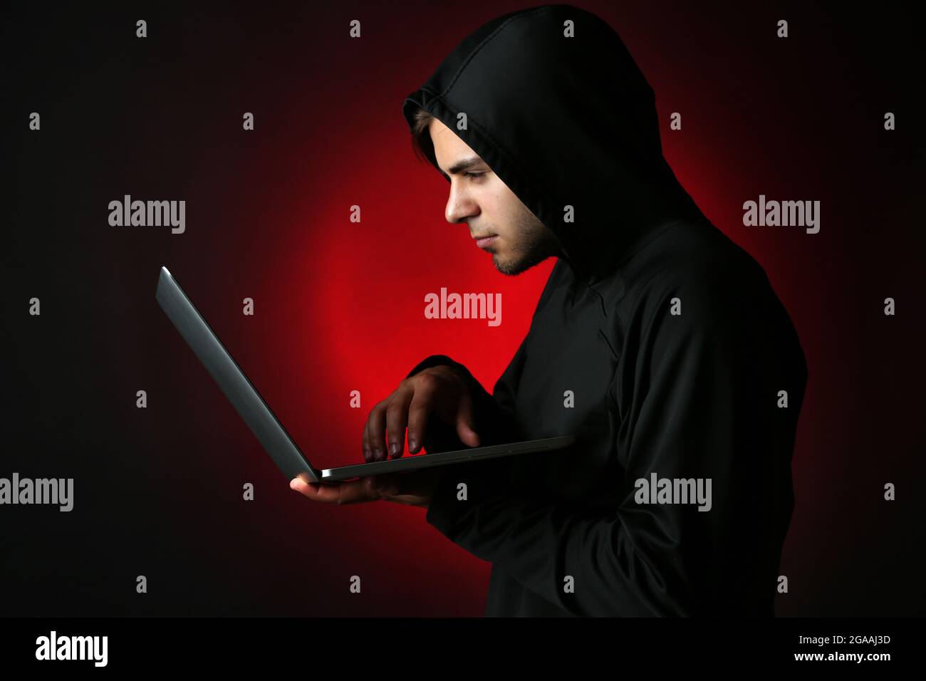 Hacker with computer and laptop on colorful dark background Stock Photo ...
