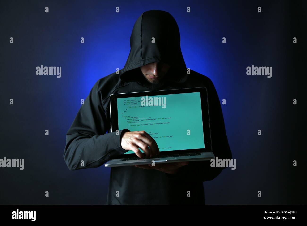Hacker with computer and laptop on colorful dark background Stock Photo ...