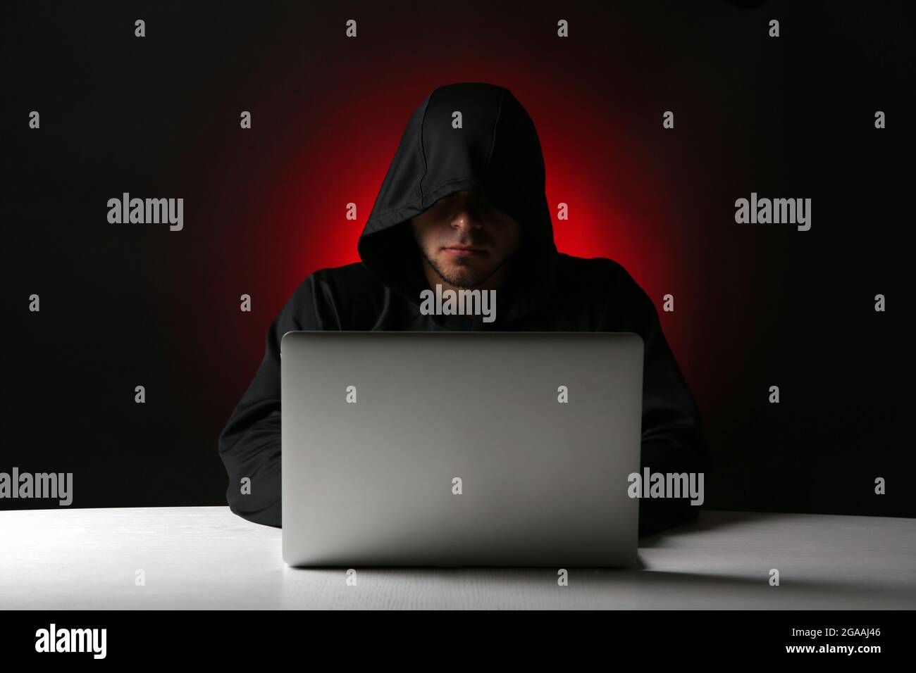 Hacker with computer and laptop on colorful dark background Stock Photo ...