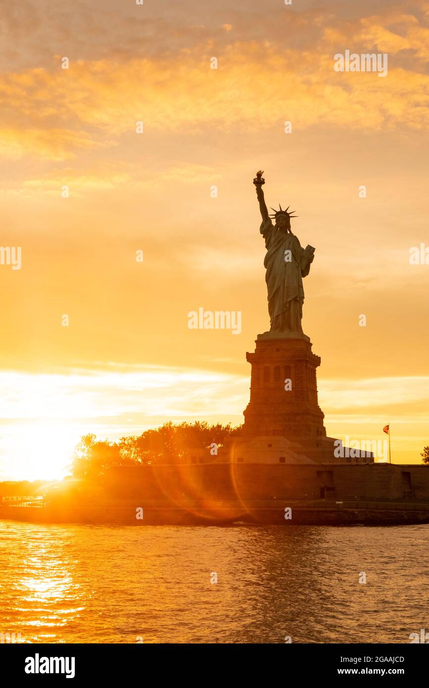 The Statue of Liberty at New York city during sunset Stock Photo - Alamy