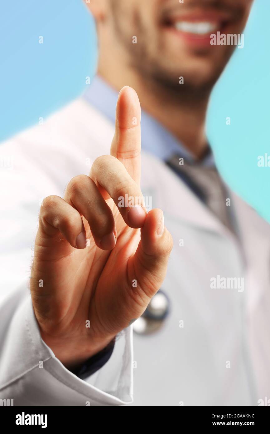 Doctor pointing his finger up, closeup Stock Photo - Alamy