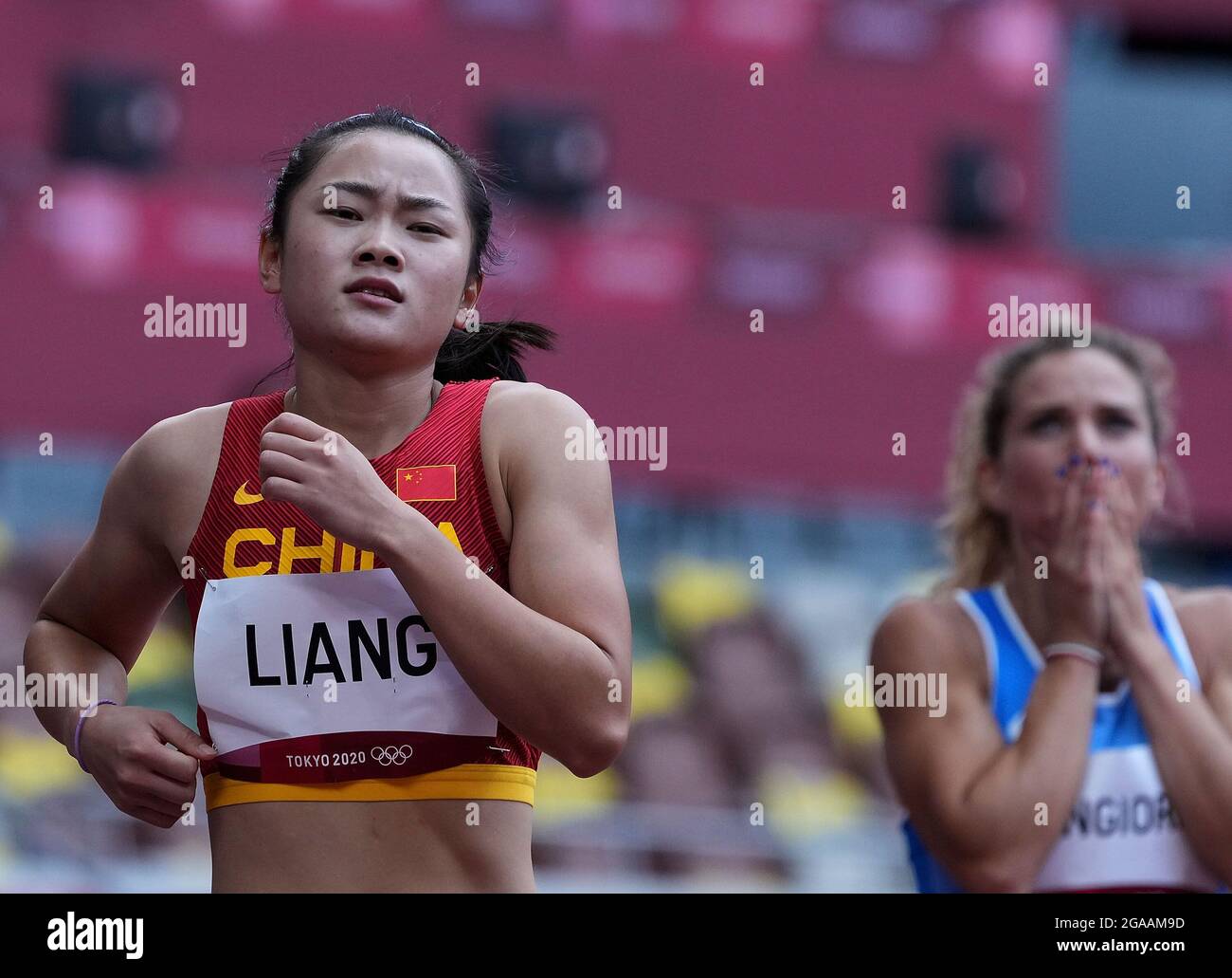 Tokyo, Japan. 30th July, 2021. Liang Xiaojing (L) of China reacts ...