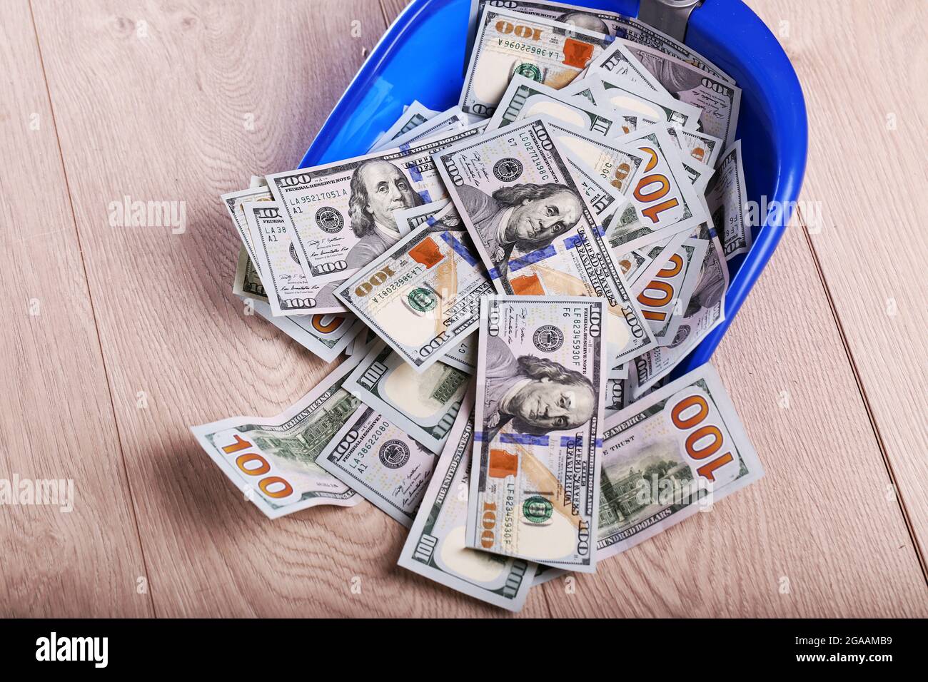 Broom sweeping dollars in scoop from on wooden floor, closeup Stock ...
