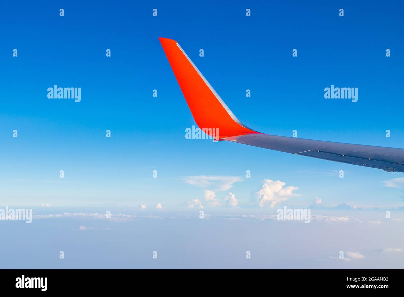 Red Wing of airplane with cloud and bluesky from window Stock Photo - Alamy